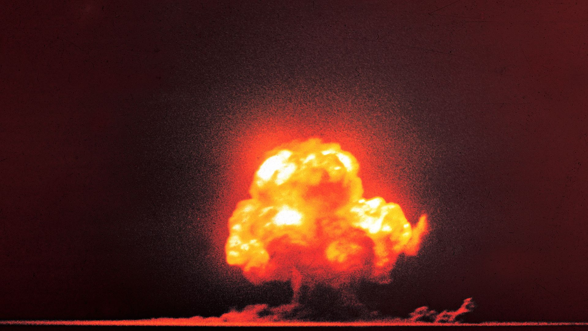 A nuclear bomb explodes in the desert, melts sand and creates a rare ...